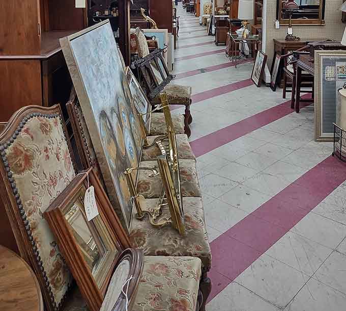 Art and frames lean casually against vintage furniture, like old friends catching up after years apart.