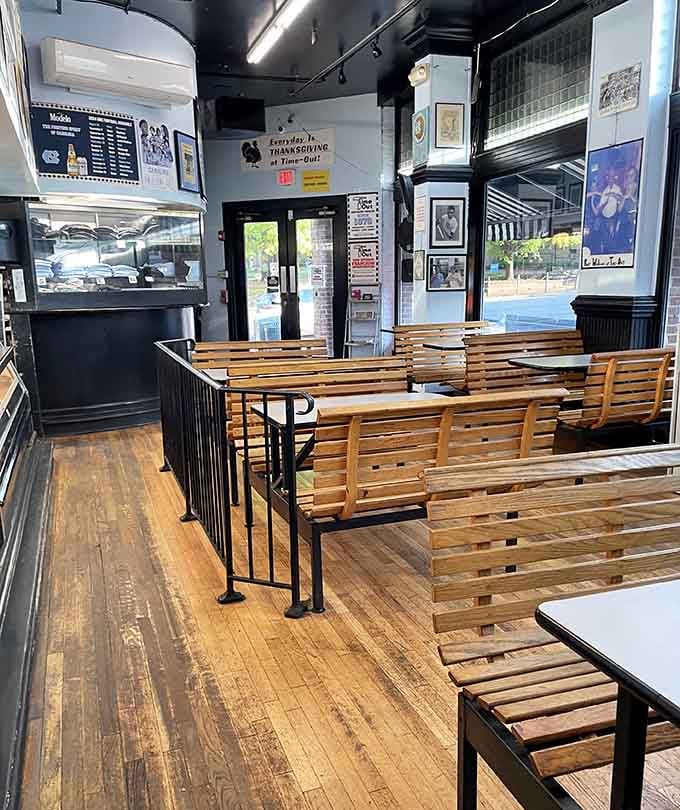 Wooden bench seating and framed photos on the walls create an atmosphere that's part diner, part community gathering spot entirely.