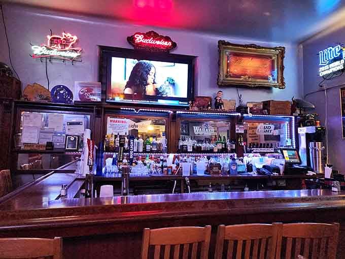 That bar setup with vintage neon signs creates the kind of atmosphere where strangers become friends over brisket.