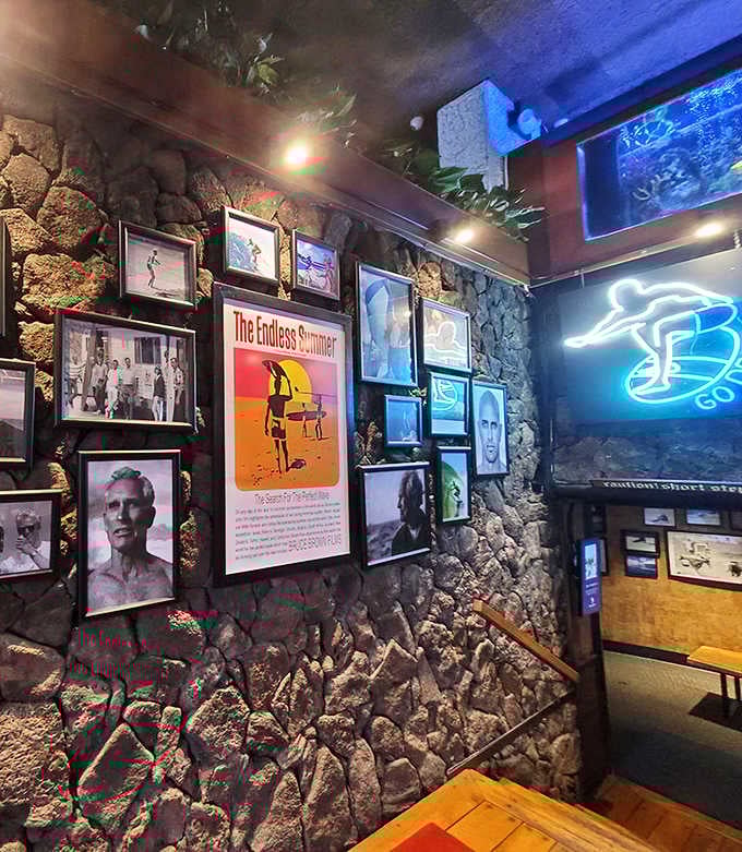 The stone wall gallery celebrates Hawaii's surf culture with vintage photos and memorabilia that tell stories of waves conquered.