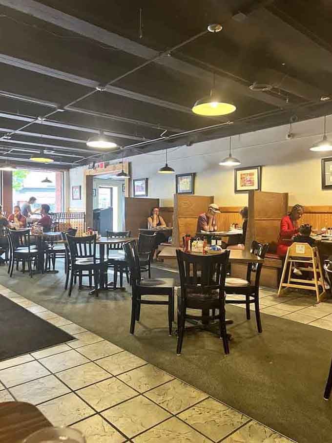 Spacious booths and warm lighting create the kind of comfortable atmosphere where breakfast conversations linger long after the plates are empty.