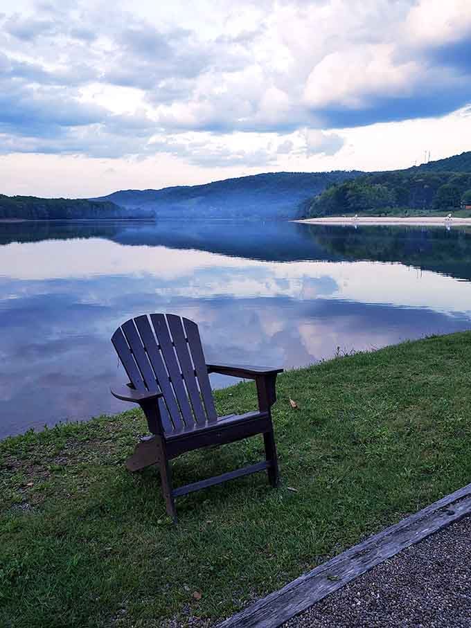 An Adirondack chair positioned for maximum lake-gazing potential. The perfect spot to contemplate life's big questions—or just nap.