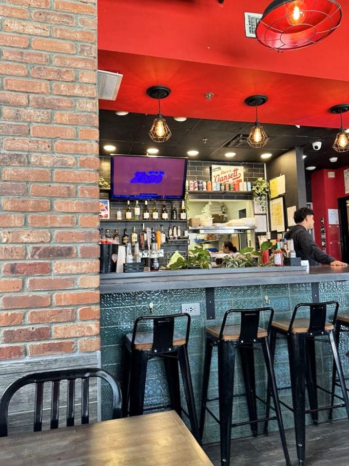 The bar area balances maritime utility with unexpected charm - those pendant lights casting a glow that makes everyone look like they're in a seafood commercial.
