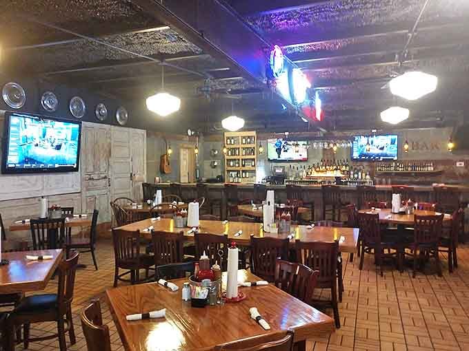 The bar area where strangers become friends over shared appreciation of smoke and sauce. Those TVs have witnessed countless "mmm" moments.