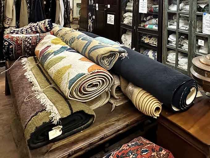 Rolled textiles tell tales of looms, hands, and traditions – each rug a narrative waiting to unfold across your living room floor.