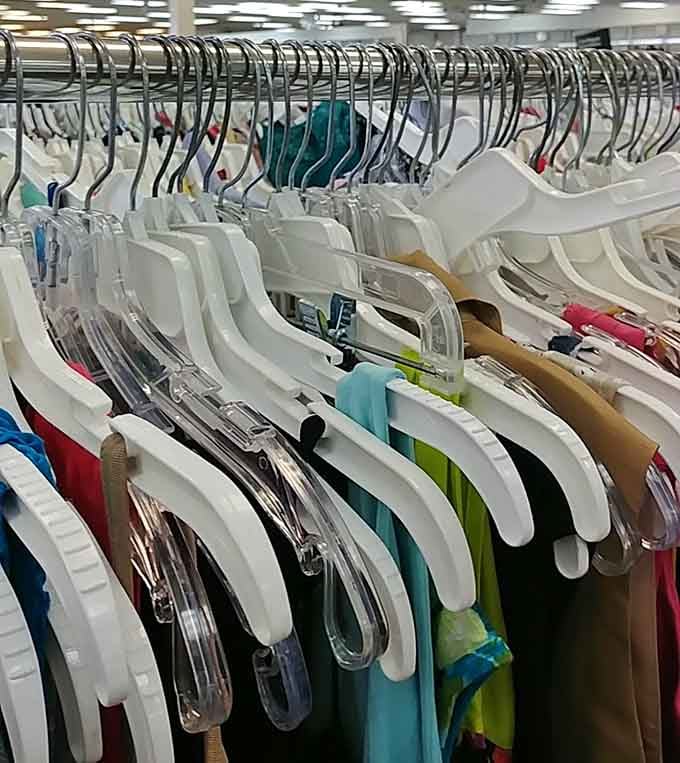 The uniform white hangers create an oddly satisfying visual rhythm, like piano keys waiting for the right shopper to play their tune.