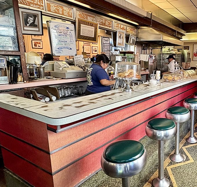 Counter seating where strangers become temporary neighbors, sharing nothing but space and the mutual appreciation of a well-made breakfast.