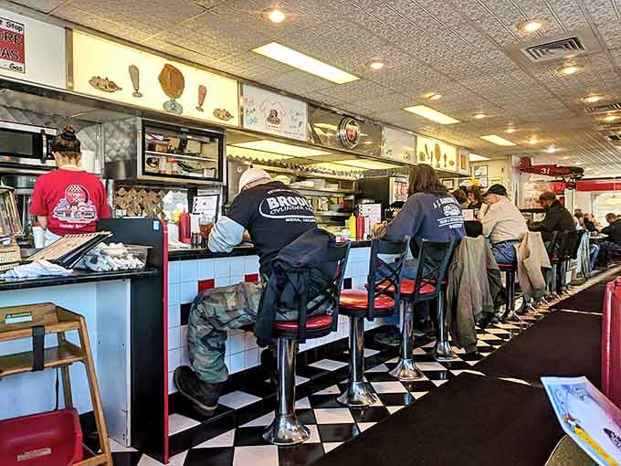 The counter seats&mdash;where solo diners become regulars and the breakfast show unfolds before your eyes. Notice the perfectly aligned stools awaiting their audience.