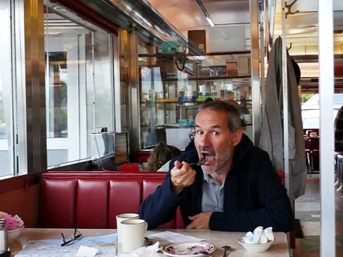 A patron enjoying what appears to be a transcendent bite—the universal expression that says, "You need to try this immediately."