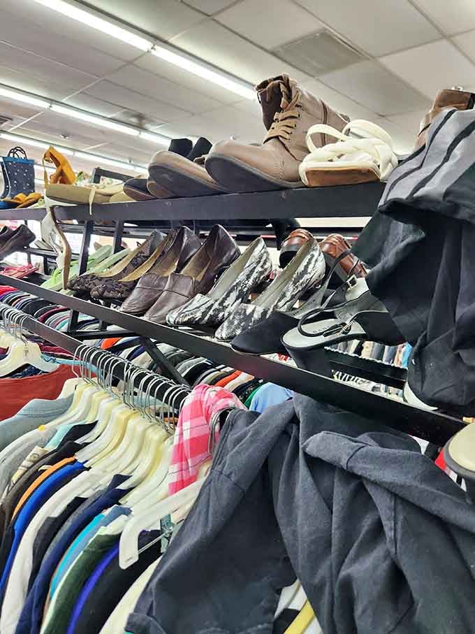 Footwear finds perched above clothing racks like birds of fashion. Those tan boots could take someone from thrift store to fashion statement in one purchase.