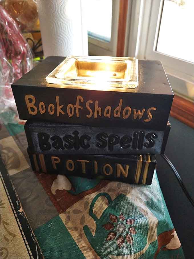 "Book of Shadows" candle holder brings mystical ambiance to any room. Perfect for summoning the spirit of your electricity bill that mysteriously disappeared.