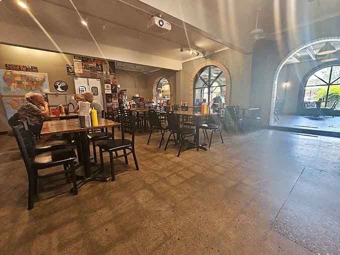 Spacious seating where conversations flow as easily as the drinks, with arched windows framing the Louisville day outside.