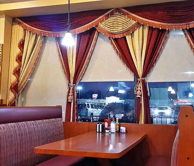 The dining room's warm wood and burgundy upholstery create that perfect "everybody knows your name" neighborhood vibe.