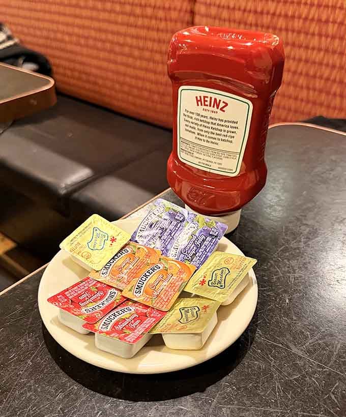 The condiment caddy&mdash;where Heinz ketchup reigns supreme and jam packets wait patiently for their moment to shine. A tabletop still life of deli essentials.
