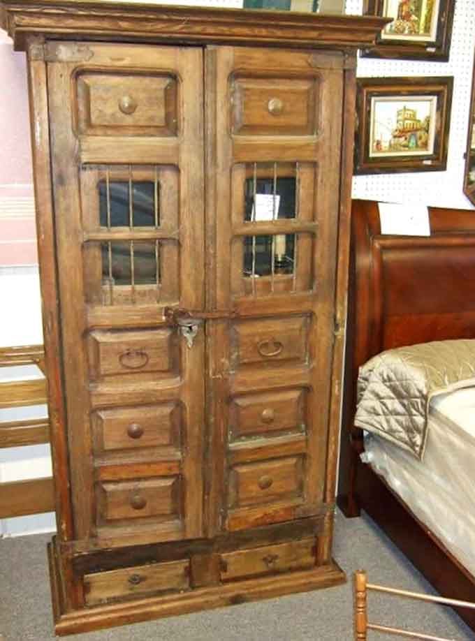 Not just a cabinet, but a time capsule. Those weathered wooden doors have protected family treasures through countless moves and memories.