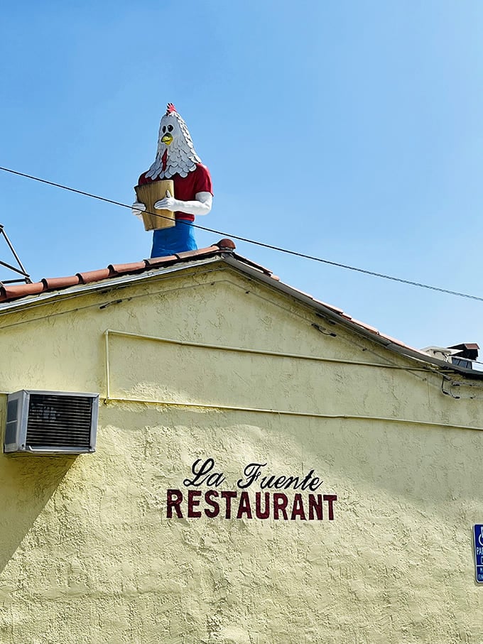 A fiberglass boy with a chicken head guards Los Angeles from his rooftop throne.