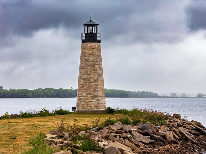This stone lighthouse stands weathered and strong, having guided ships through storms for more than a century now.