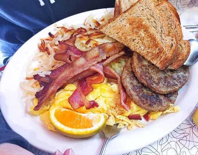 This hearty breakfast plate loaded with bacon, sausage, and eggs fuels adventures or lazy Sunday mornings.
