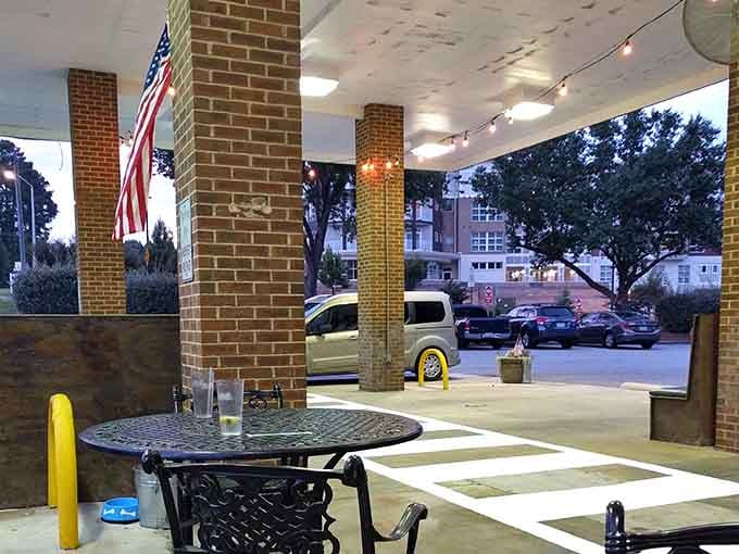 Covered outdoor seating with metal tables lets you enjoy North Carolina evenings while contemplating your order.