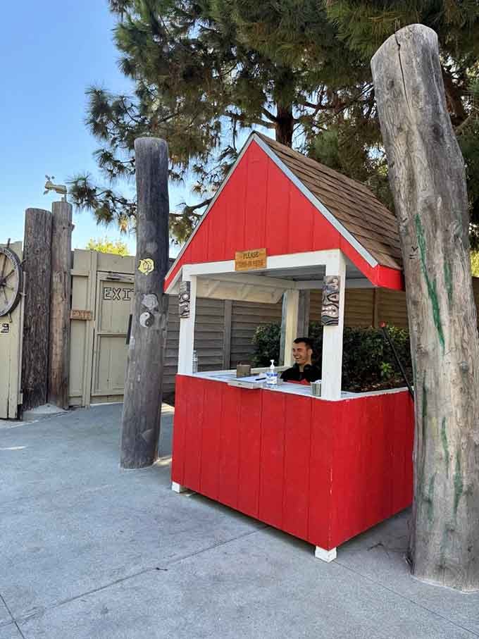 That cheerful red booth welcomes families into a world where play is taken seriously and fun is the priority.