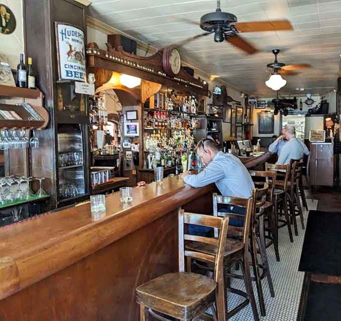 That wooden bar has absorbed more stories than most libraries, still serving drinks with the same welcoming spirit.