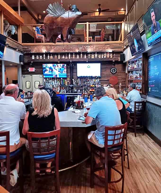 The impressive bar, crowned with a wooden bear sculpture, offers liquid companionship for your barbecue journey &ndash; bourbon and smoked meat being natural allies.