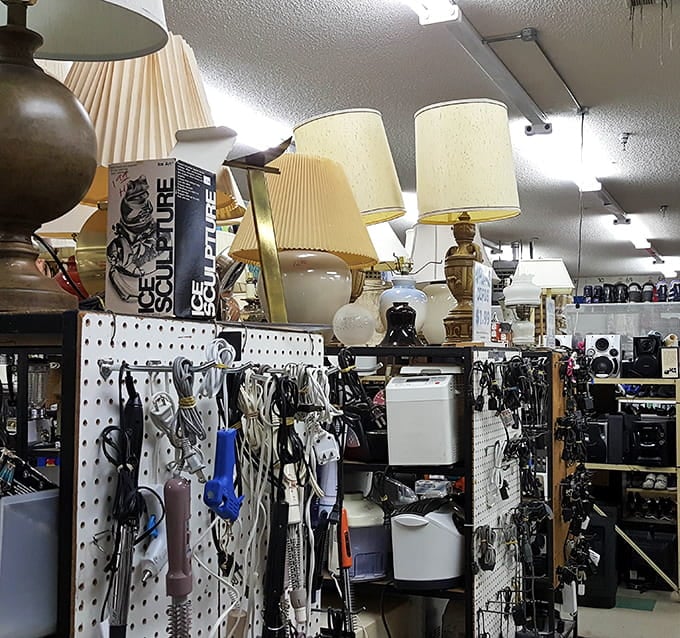 Lamps and electrical odds and ends creating a display that's part hardware store, part time capsule of home d&eacute;cor.