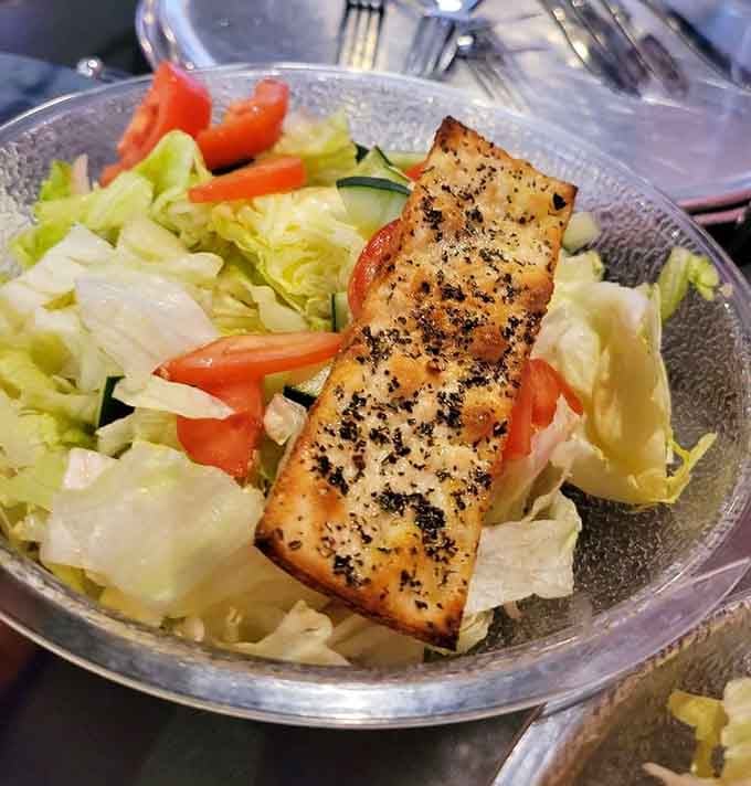 Even the salad gets generous treatment here, topped with seasoned bread that could be a meal itself.