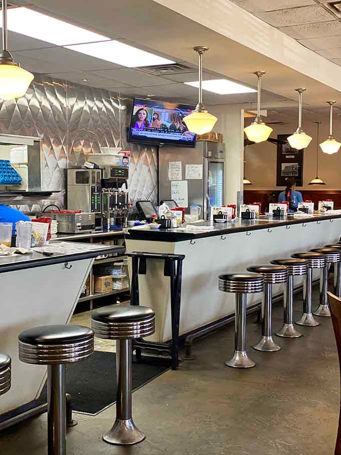 Classic diner counter seating with chrome stools: where solo diners become part of the breakfast community.