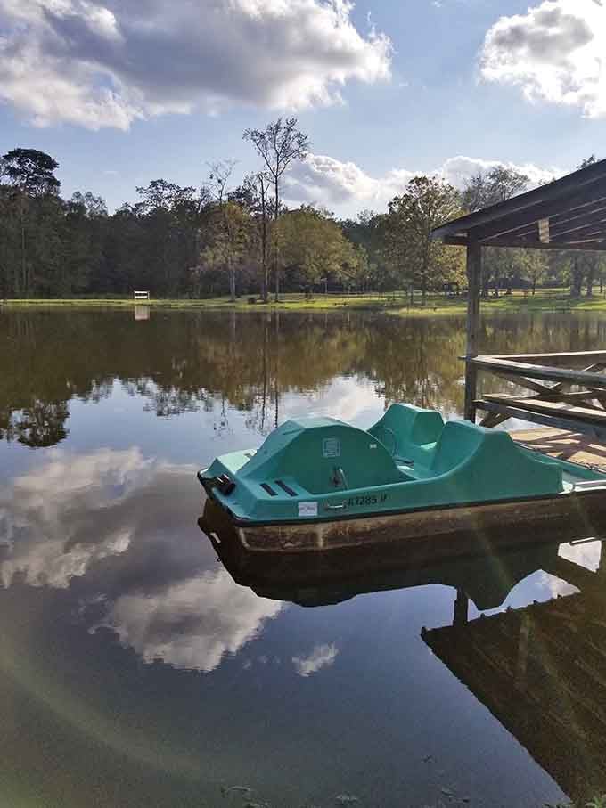 Paddle boats waiting patiently for their next adventure across water so clear it reflects the sky perfectly.