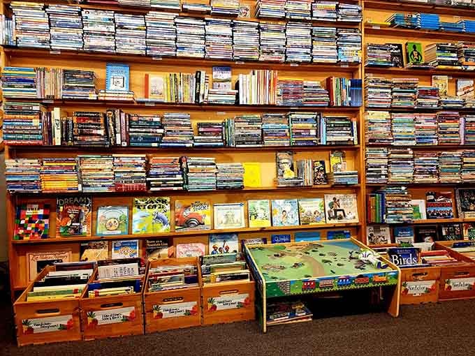 Wooden shelves and wicker baskets create an inviting space where kids can discover their next favorite story without any pressure or fuss.