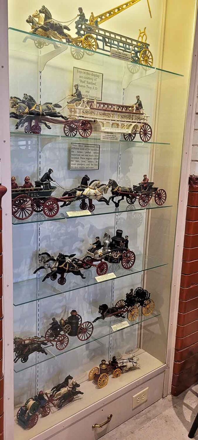 Miniature perfection captures the majesty of horse-drawn fire engines, each tiny detail lovingly recreated for admirers.