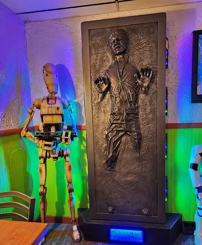 Han Solo frozen in carbonite stands guard, flanked by droids, creating the most entertaining dining companion situation imaginable today.