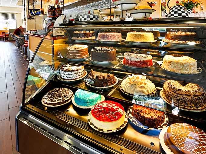 This dessert case is basically edible architecture, each cake a towering testament to sugar's infinite possibilities.