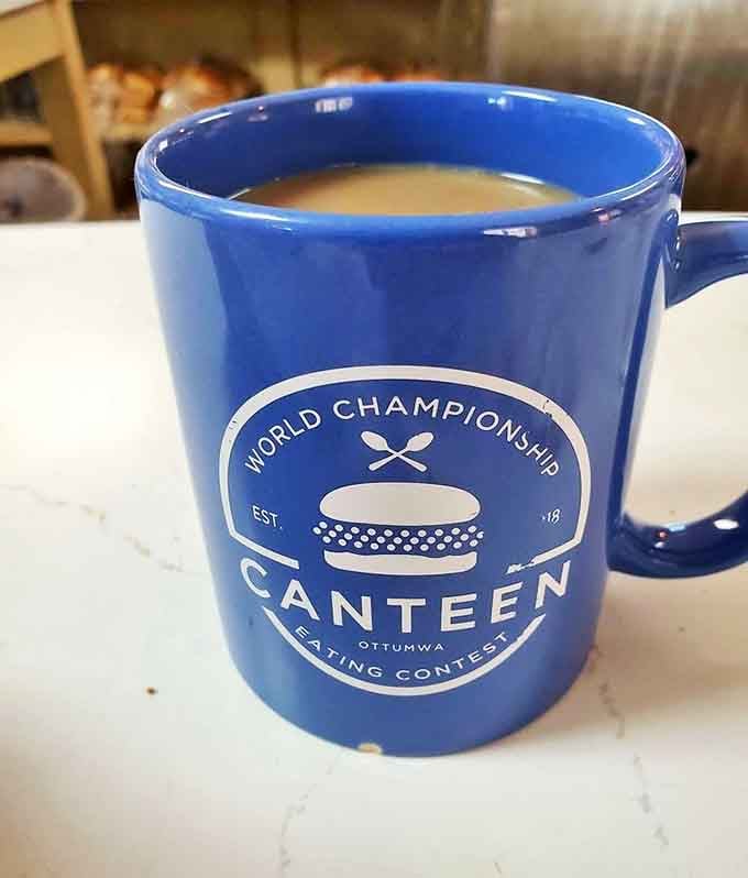 This isn't just coffee&mdash;it's a blue mug of liquid motivation advertising the establishment's sandwich-eating prowess. Challenge accepted!
