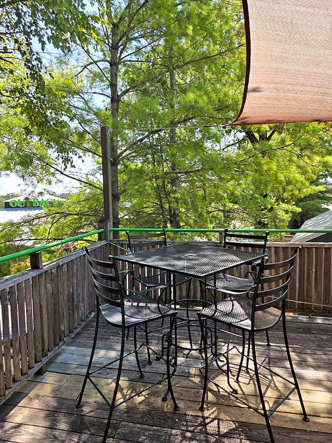 Outdoor seating under actual tree branches, proving nature and nachos can absolutely coexist in perfect harmony.