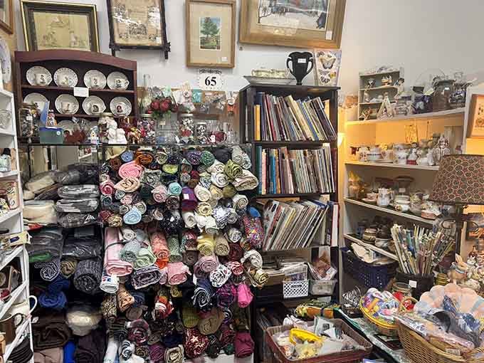 Rolled fabrics create a rainbow tower, surrounded by treasures that make you question why you came in with a budget.