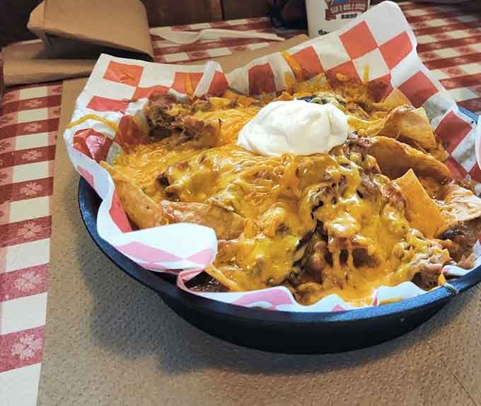 Nachos piled high with all the fixings prove that sometimes more really is more, especially with melted cheese.