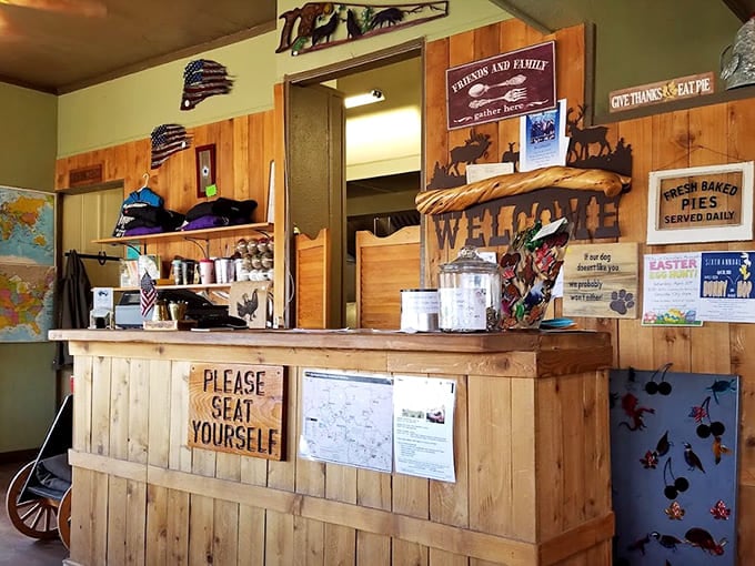 The counter area welcomes you with a "Please Seat Yourself" sign – small-town hospitality at its finest and most genuine.
