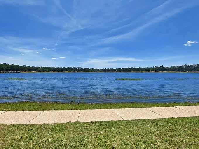 Crystal-clear lake water stretches to the horizon, inviting you to walk the shoreline path and forget your troubles for a while.