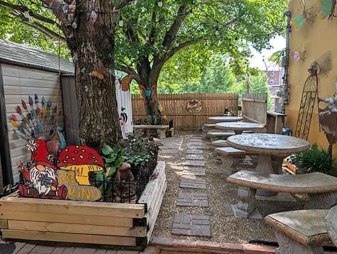 The whimsical outdoor patio features garden gnomes and round tables, perfect for sipping coffee while watching Asheville pass by.