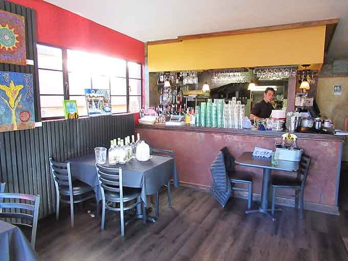 The bar area where skilled hands craft cocktails that complement the kitchen's Mediterranean-inspired tapas selections perfectly every time.