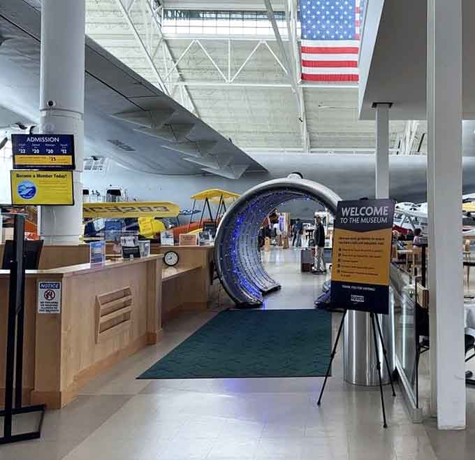 The illuminated entrance tunnel beckons visitors forward, creating anticipation for the mechanical marvels waiting beyond that glowing portal.
