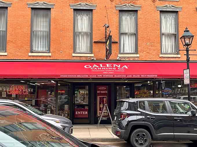 Bright red awnings pop against historic brick, proving that tradition and personality can absolutely coexist in perfect harmony.