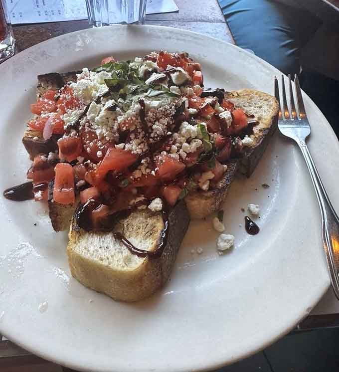 Bruschetta piled high with tomatoes, basil, and cheese on toasted bread. This appetizer could honestly be the whole meal.