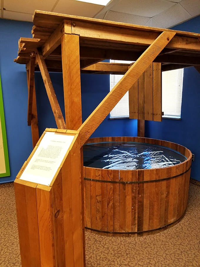 This wooden drop bath apparatus looks like something from a medieval dungeon rather than a 20th-century medical facility.