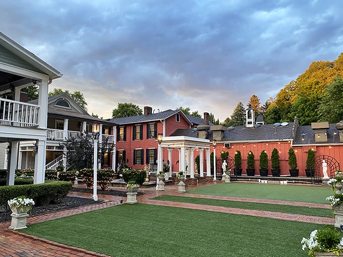 The Historic Buxton Inn glows at twilight, its colonial charm suggesting that George Washington might have actually enjoyed staying here, powdered wig optional.