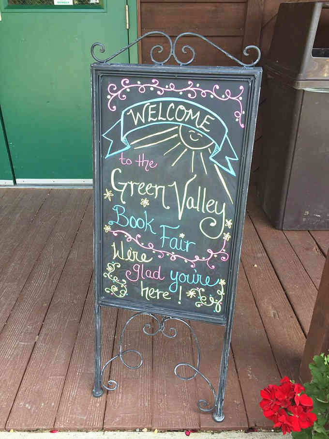 That welcoming chalkboard message sets the tone perfectly: this is a place where book lovers belong and thrive.