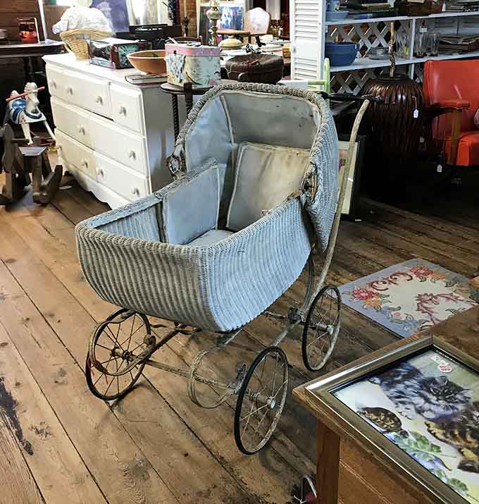 A vintage baby carriage sits ready to charm collectors who appreciate craftsmanship from a gentler era.