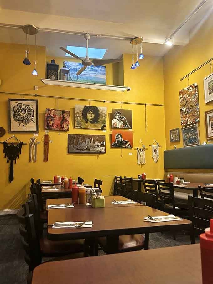Yellow walls adorned with eclectic art create a dining space that's equal parts gallery and comfort zone.